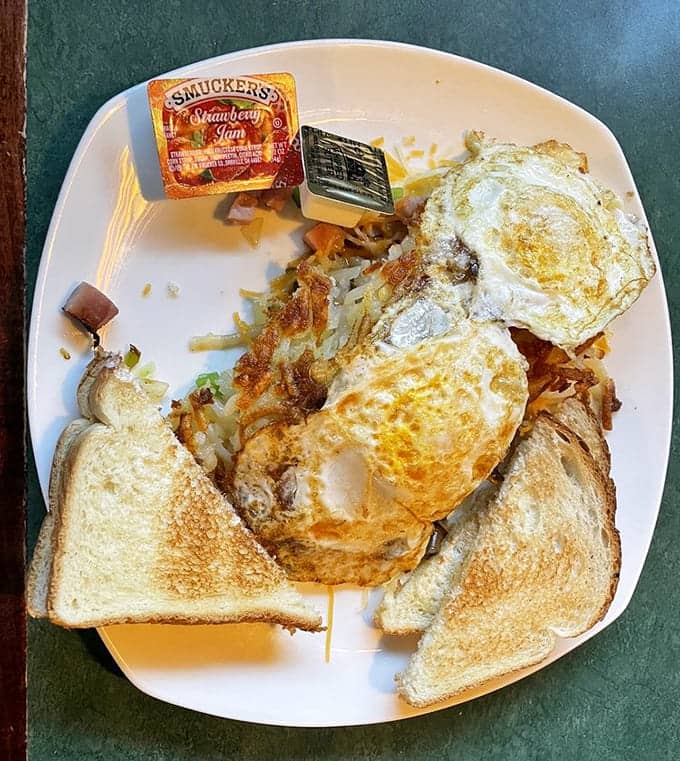 When breakfast meets lunch on one plate, complete with eggs, hash browns, and toast, you've found the cure for any morning blues.