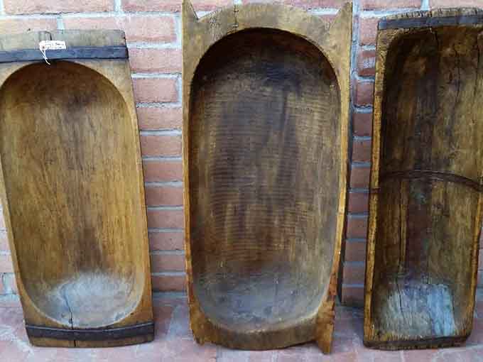 Wooden bowls worn smooth by decades of use, each one a testament to when kitchen items were built to outlast their owners.