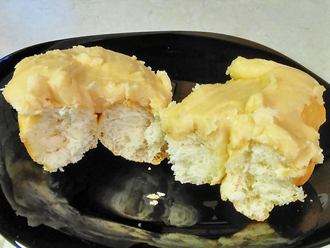 The caramel bismarck reveals its creamy secret &ndash; a pillowy donut exterior giving way to a center that dreams are made of.