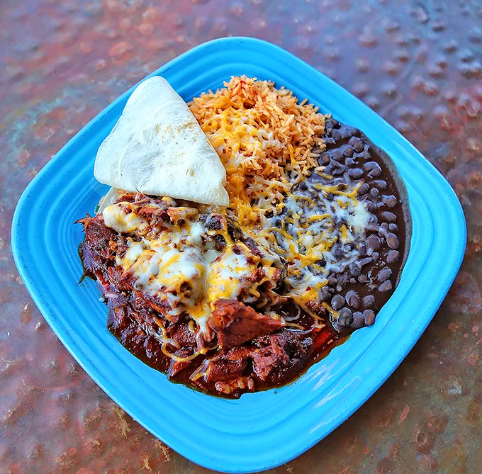 This isn't just dinner - it's a flavor fiesta with tender carne adovada, Spanish rice, and black beans.