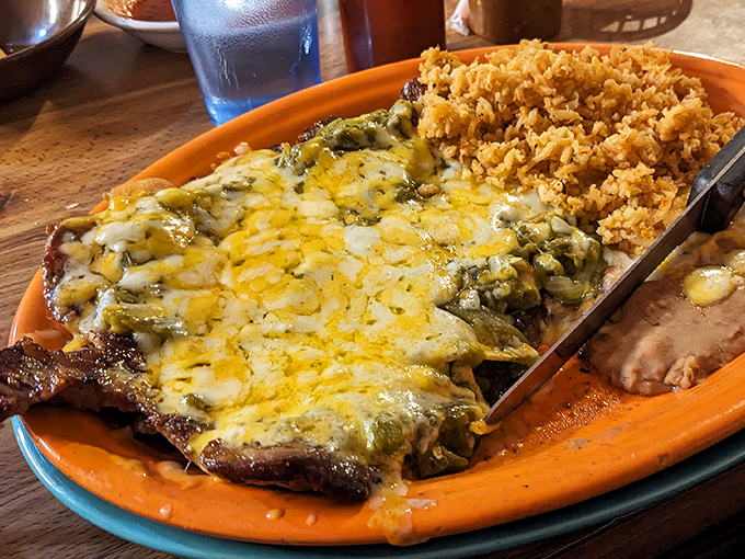 Behold the legendary Carne Asada &ndash; tender beef blanketed with melted cheese and green chiles that would make your abuela weep with joy.