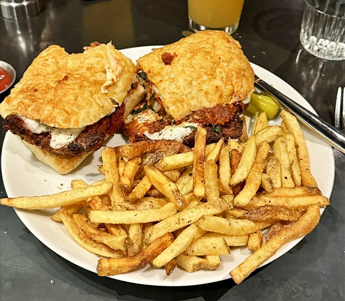 This isn't just a sandwich; it's chicken parmesan architecture &ndash; crispy cutlet, melty cheese, and zesty sauce between focaccia, with golden fries standing guard.