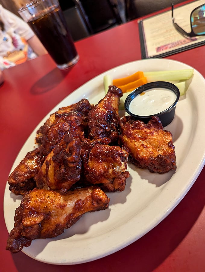 A platter of wings showcasing different sauces &ndash; each one house-made with the kind of attention that turns simple bar food into a destination dish.
