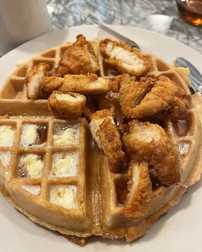 Chicken and waffles, Vermont-style! Crispy fried chicken pieces perch atop a golden waffle &ndash; add maple syrup and prepare for a sweet-savory flavor explosion.