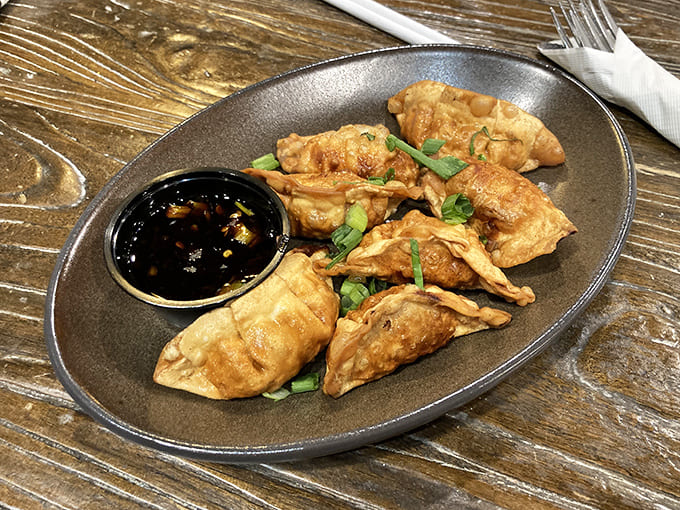 Golden-brown chicken potstickers arrive perfectly crisp outside, tender inside &ndash; the ideal starter to share or selfishly devour all by yourself.