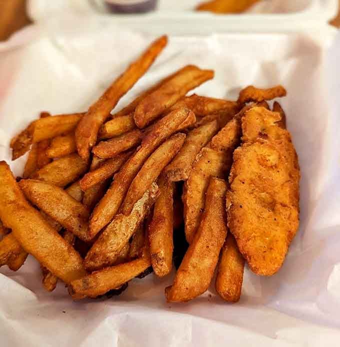 Comfort food perfection: Golden fries and crispy chicken strips &ndash; the savory counterpoint to sweet treats that keeps locals coming back.