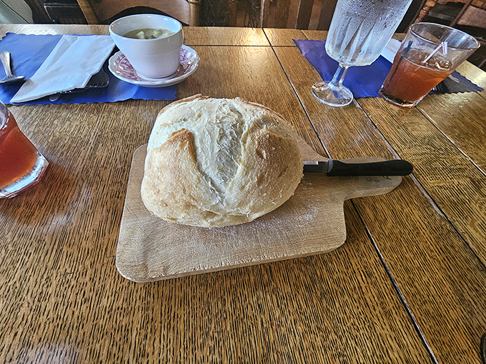 The bread service features a rustic loaf with a crackling crust and pillowy interior, perfect for sopping up every last bit of sauce.