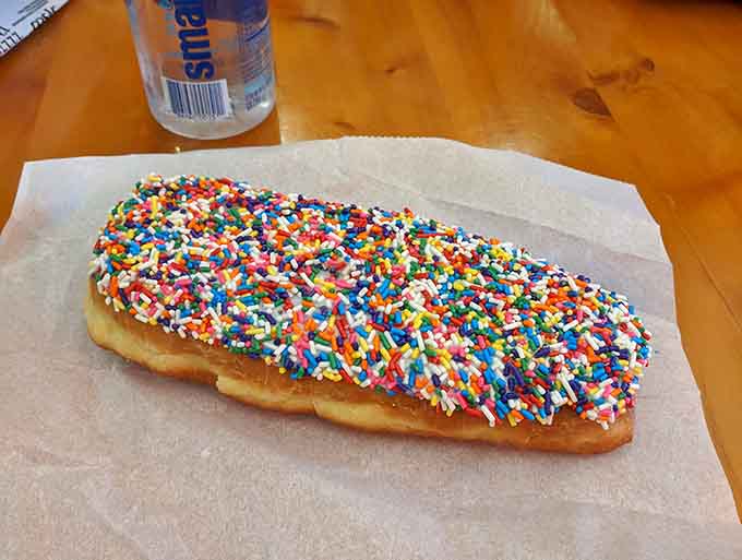 That long john covered in rainbow sprinkles is basically happiness in pastry form, no therapy required.