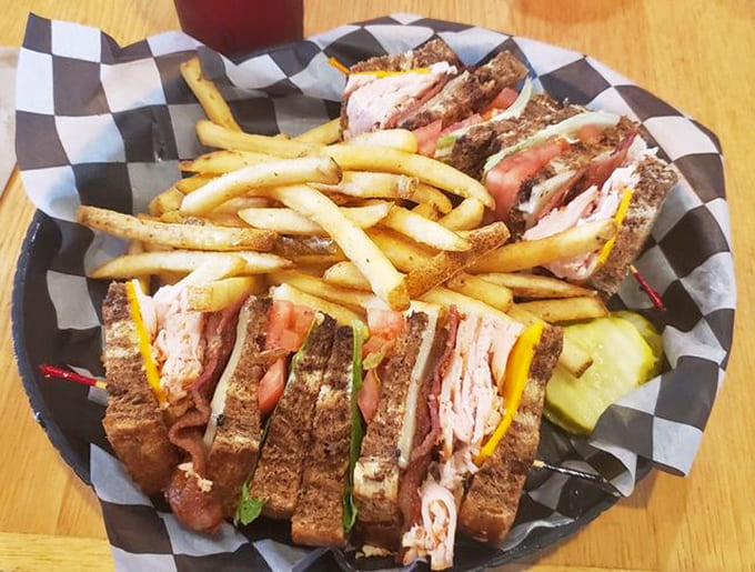 The club sandwich arrives as a towering achievement in sandwich engineering, stacked with turkey, ham, bacon, and all the fixings your heart desires.