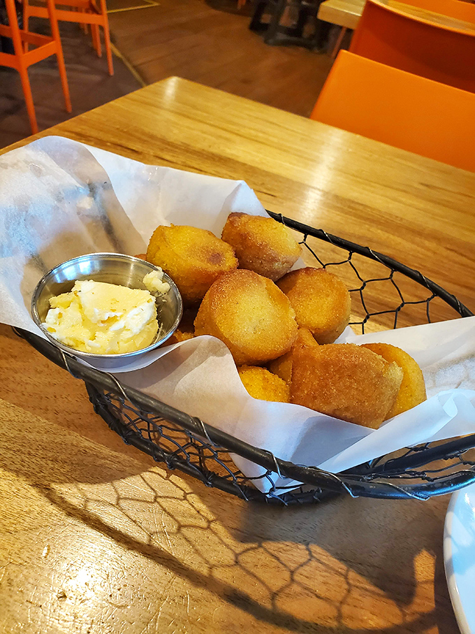 These cornbread nuggets arrive hot and ready for their butter bath – resistance is futile, seconds are inevitable.