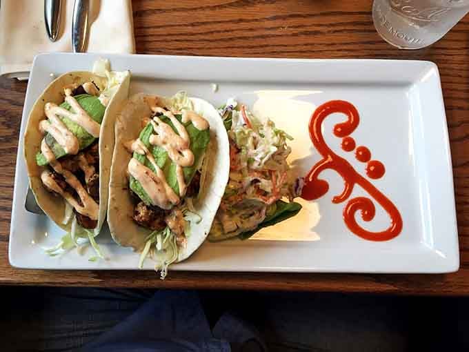 Three tacos featuring blackened swordfish, fresh slaw, and chipotle lime ranch create a flavor combination that shouldn't work but absolutely does.