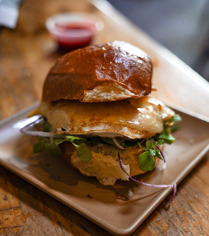The Day Maker lives up to its name with egg, cheddar, and that magical bacon fat aioli on brioche &ndash; basically sunshine between bread.