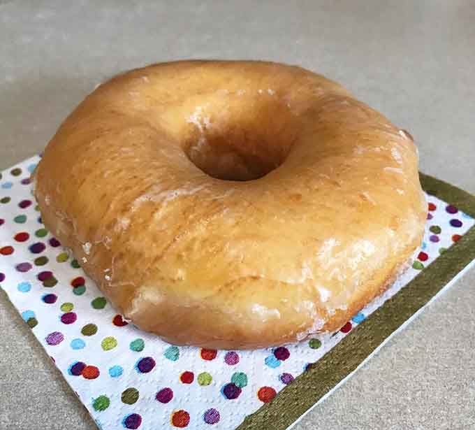The classic glazed doughnut achieves perfection through simplicity, proving sometimes less really is more delicious.