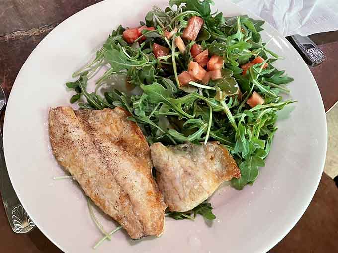 Levrek Branzino showcases Mediterranean striped bass with crispy skin and delicate flesh over peppery arugula greens.