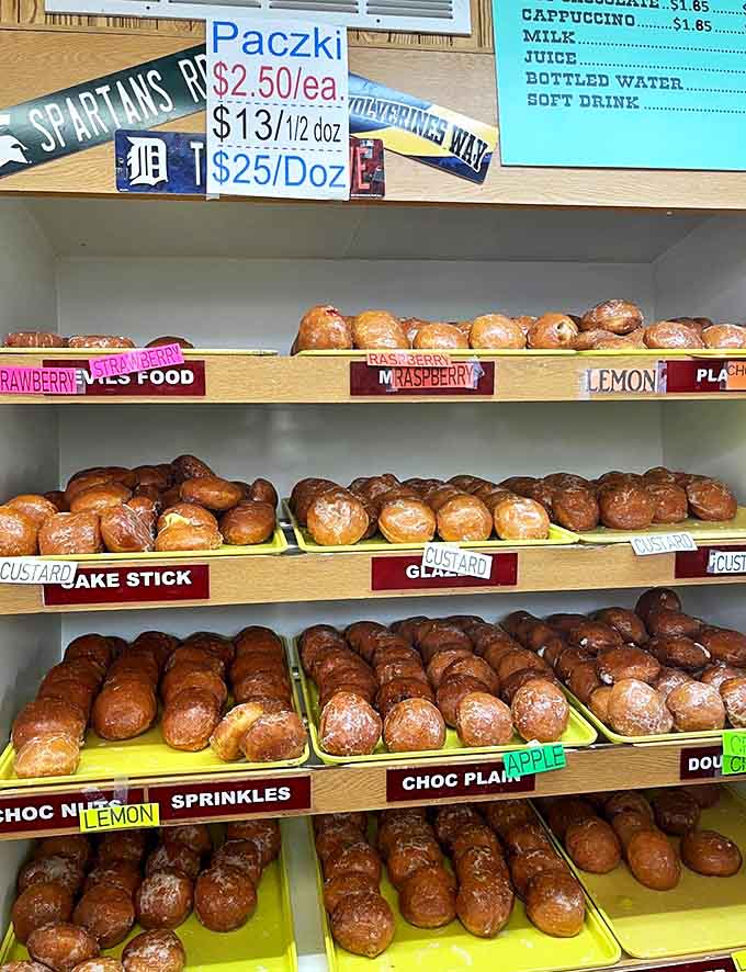 Shelves lined with freshly made donuts create a mouthwatering display that makes choosing just one variety nearly impossible.