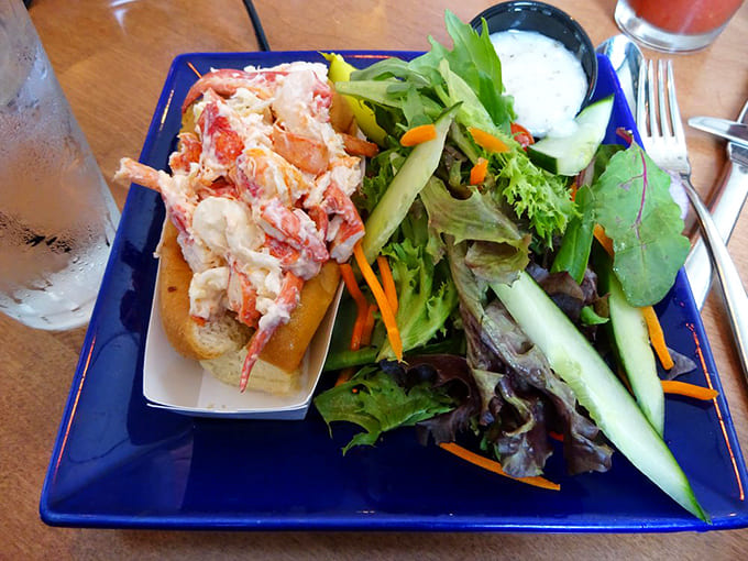 The lobster roll paired with a fresh salad creates the perfect balance of indulgence and virtue, though we all know which one you're really here for.