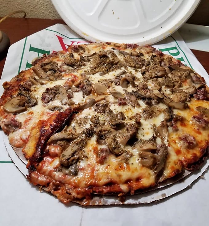 Double mushrooms and sausage prove that sometimes more is actually more, especially when that thin crust holds everything together beautifully.