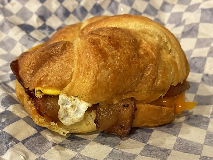 A flaky croissant breakfast sandwich with bacon and egg proves that mornings at Dufner's are just as magical.