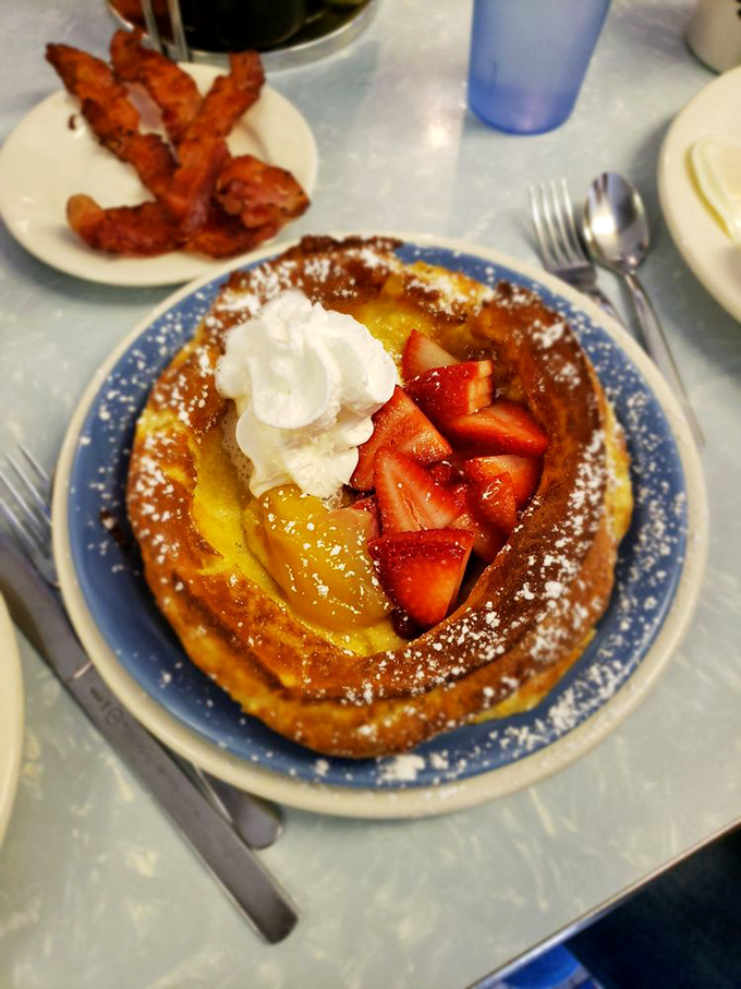 Strawberry fields forever &ndash; fresh berries and powdered sugar transform this Dutch pancake into a morning masterpiece.