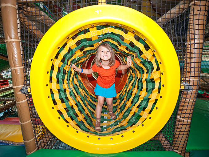 A young explorer navigates the twisting yellow tunnel&mdash;part of the elaborate playground system that keeps kids entertained for hours.