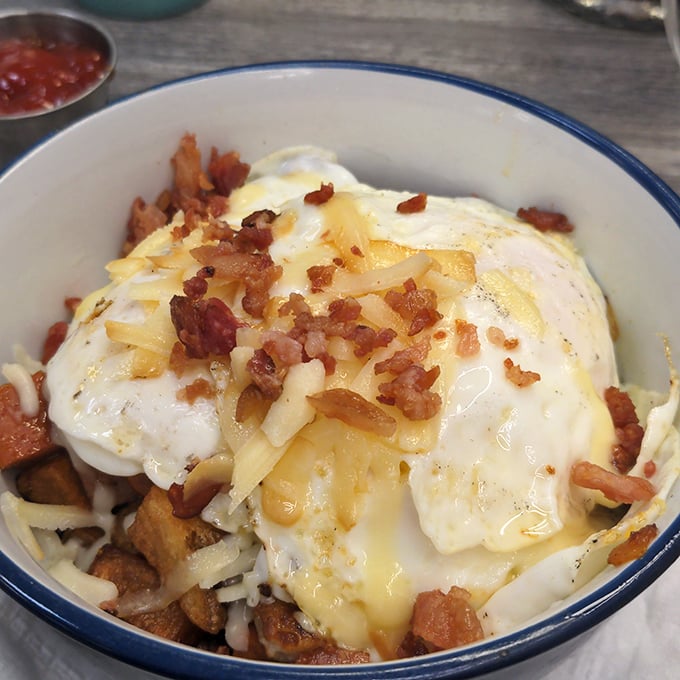 This hearty bowl combines crispy potatoes, melted cheese, bacon bits, and sunny-side-up eggs &ndash; the breakfast equivalent of a warm hug on a cold Vermont morning.