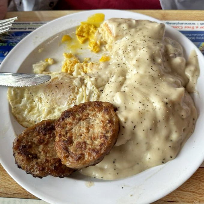 Country-style breakfast with eggs, sausage patties, and that legendary gravy &ndash; comfort on a plate.