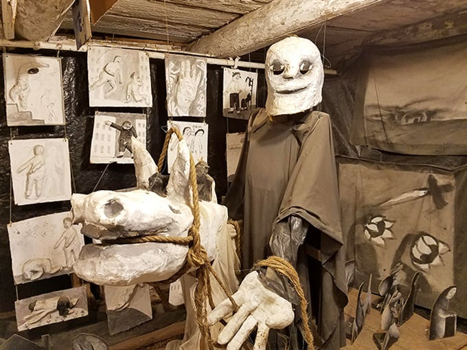 Primitive drawings and a watchful puppet create an unsettling classroom vibe, as if waiting for students to arrive for lessons in artistic resistance.