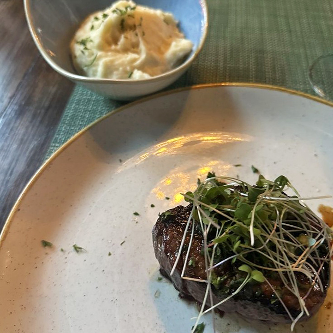 A perfectly cooked filet mignon shares the spotlight with creamy garlic mashed potatoes &ndash; comfort food elevated to fine dining status.