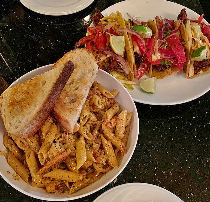 Comfort meets creativity: The pasta's rich embrace alongside those famous fish tacos proves The Black Pearl excels on both land and sea.