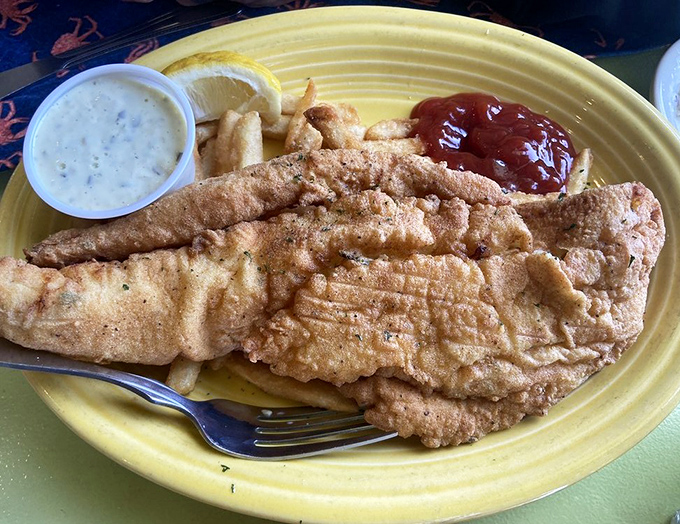 The ultimate comfort food trifecta: crispy battered fish, golden fries, and tangy tartar sauce &ndash; simple pleasures executed with the care they deserve.