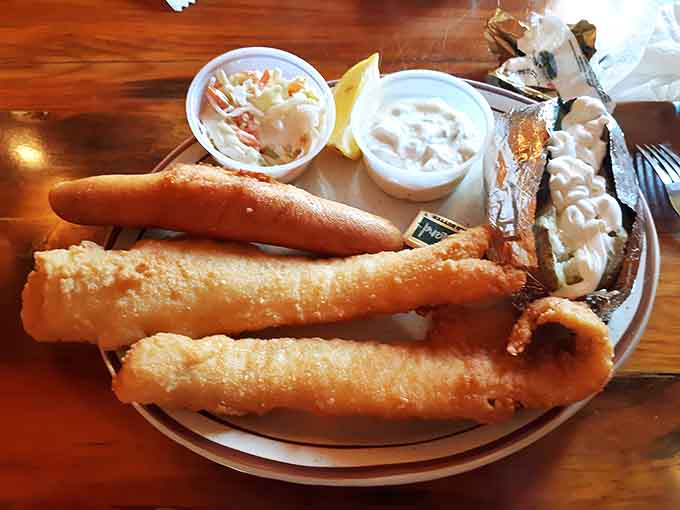 Generous portions of fried fish arrive with all the classic accompaniments, creating a plate that's as beautiful as it is delicious.