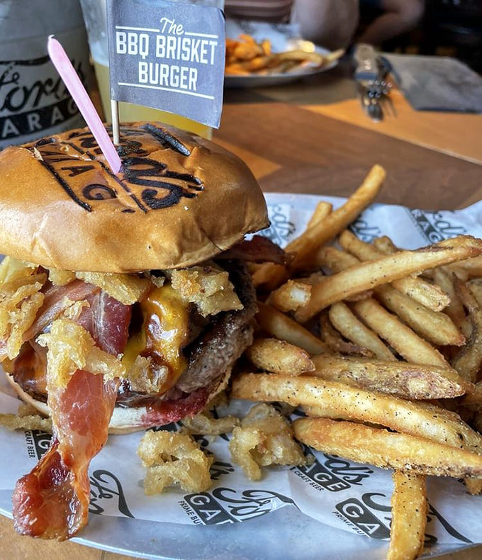 That signature Ford's Garage branding on the brioche bun holds together a masterpiece of brisket, bacon, and beef, accompanied by perfectly seasoned fries that deserve their own fan club.