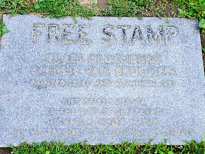 The plaque reveals the Free Stamp's prestigious pedigree: a gift from BP America to Cleveland, created by renowned artists Oldenburg and van Bruggen.