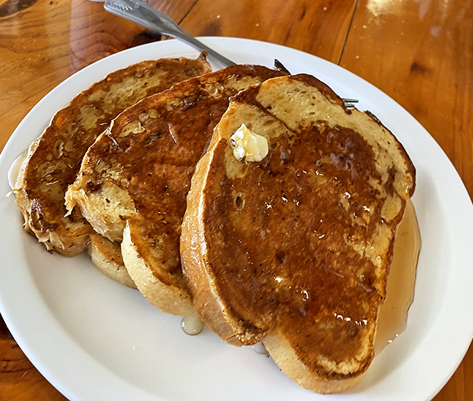 Golden-brown French toast perfection that achieves the holy grail of crispy exterior and custardy interior in every single bite.