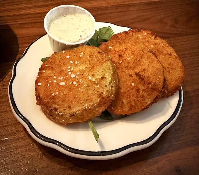 Crispy, golden-brown fried green tomatoes offer a taste of the South, executed with precision and served with creamy remoulade.