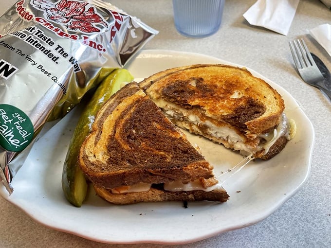 The tuna melt that launched a thousand cravings &ndash; perfectly grilled bread giving way to melty cheese and savory tuna, with that essential pickle alongside.