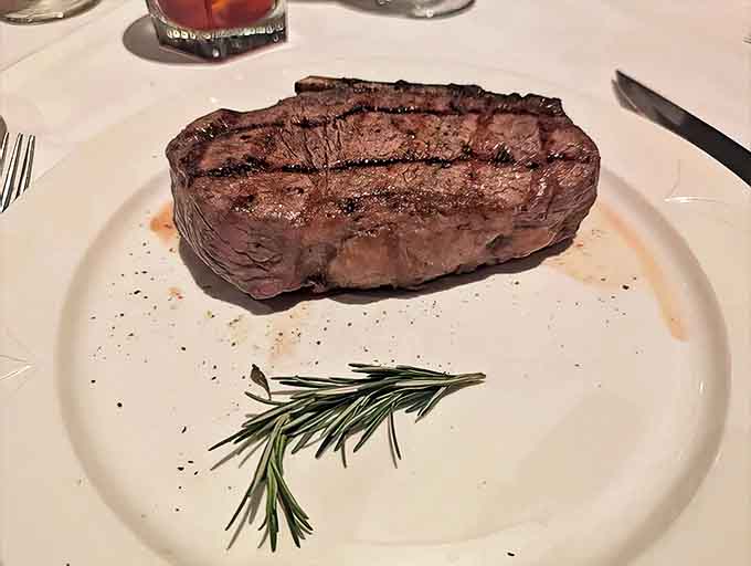 Lollipop lamb chops standing at attention like meaty soldiers, perfectly charred and ready for their mint salsa verde companion.
