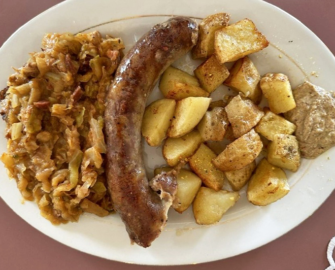 Smoky kielbasa with a perfect char, accompanied by caramelized sauerkraut and potatoes that soak up all that savory goodness.