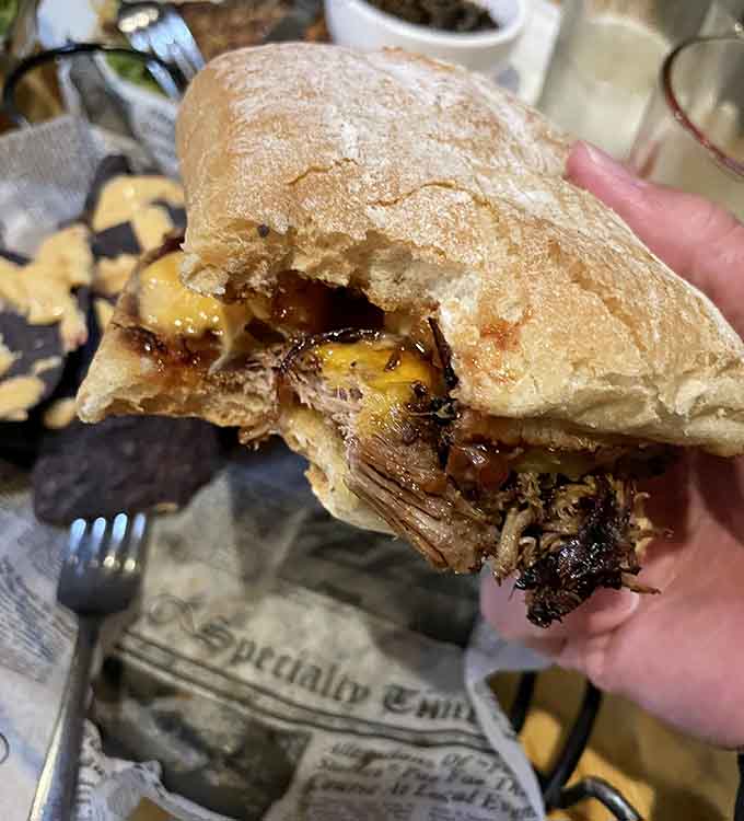 That cross-section reveals layers of barbacoa pork, melted Swiss, and chipotle mayo working together in perfect harmony.