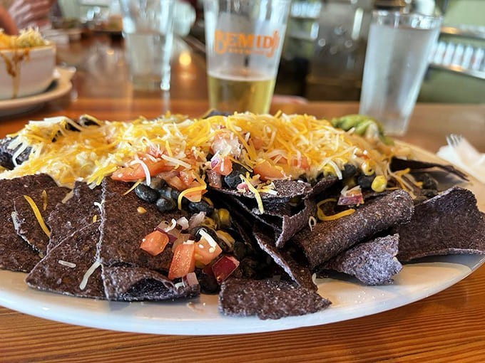 Blue corn chips piled high with all the fixings prove that nachos are basically a food group in the best possible way.