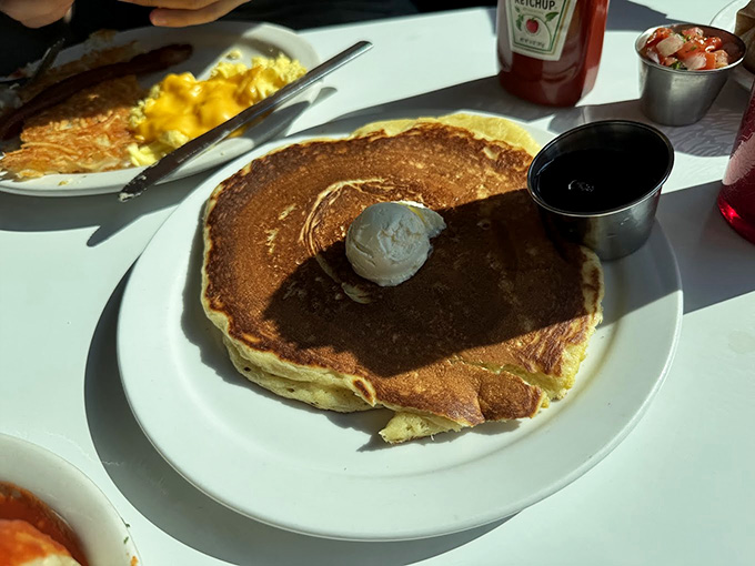 Pancakes so fluffy they practically float off the plate, ready to soak up all that syrupy goodness you're about to pour.