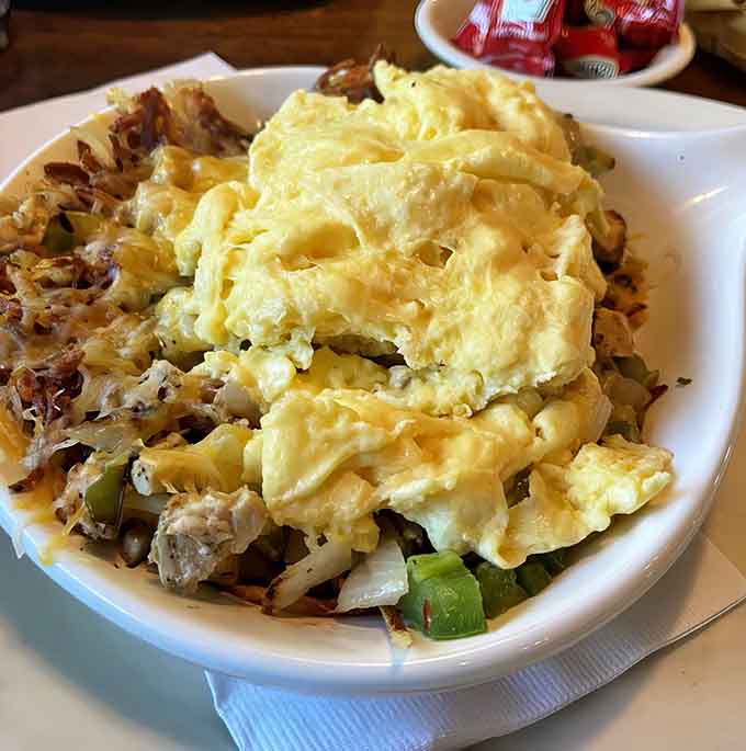 Chicken, pepper, and onion skillet with fluffy scrambled eggs delivers protein-packed satisfaction in every forkful.