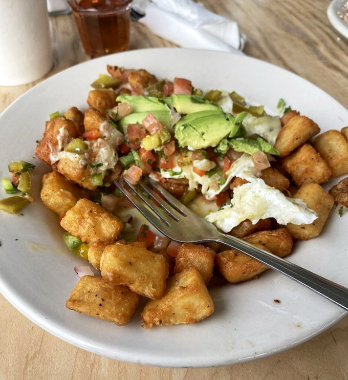 Home fries that could make a potato proud, topped with fresh avocado and pico de gallo &ndash; breakfast engineering at its finest.