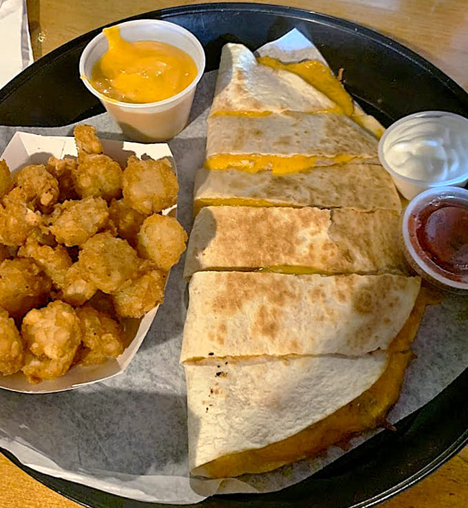 Crispy tater tots accompany perfectly grilled quesadillas, proving that some food combinations are simply meant to be together.