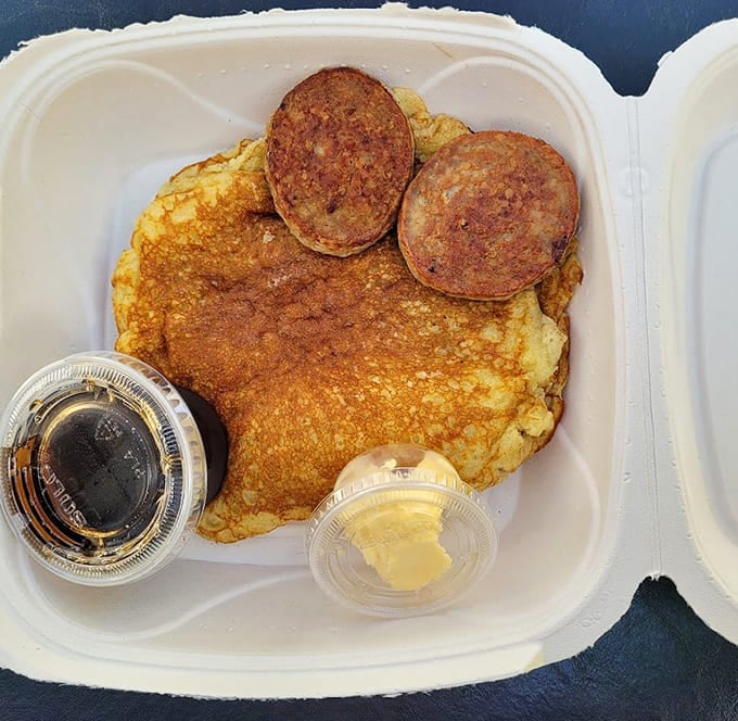 When your pancake needs its own plate and the sausage patties look like they're photobombing, you know you've ordered right.