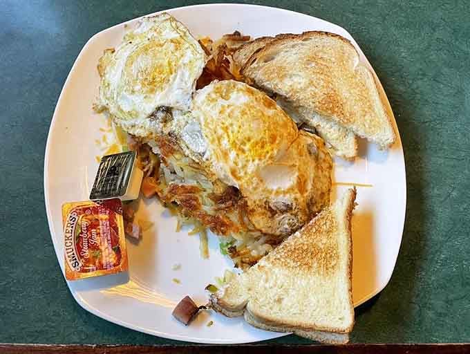 Eggs cooked to perfection sit atop golden hash browns, proving that sometimes the simplest combinations are the most satisfying breakfast choices.