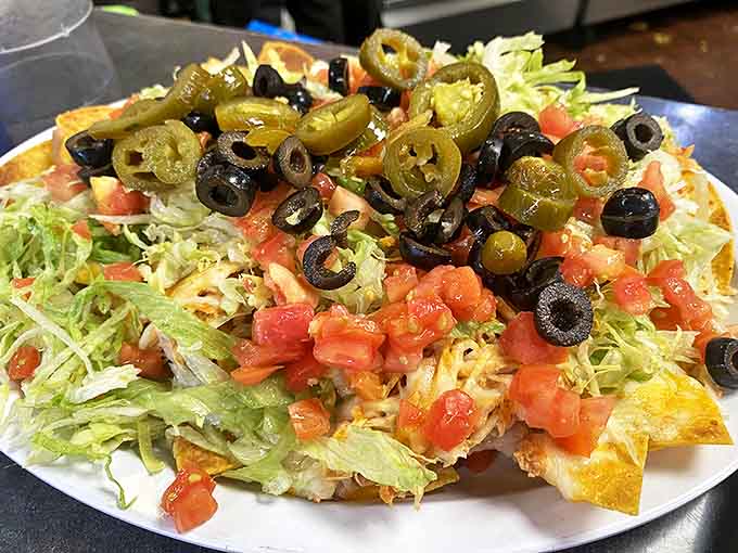 These nachos aren't messing around, piled high with jalape&ntilde;os, olives, and all the toppings that make sharing almost impossible.