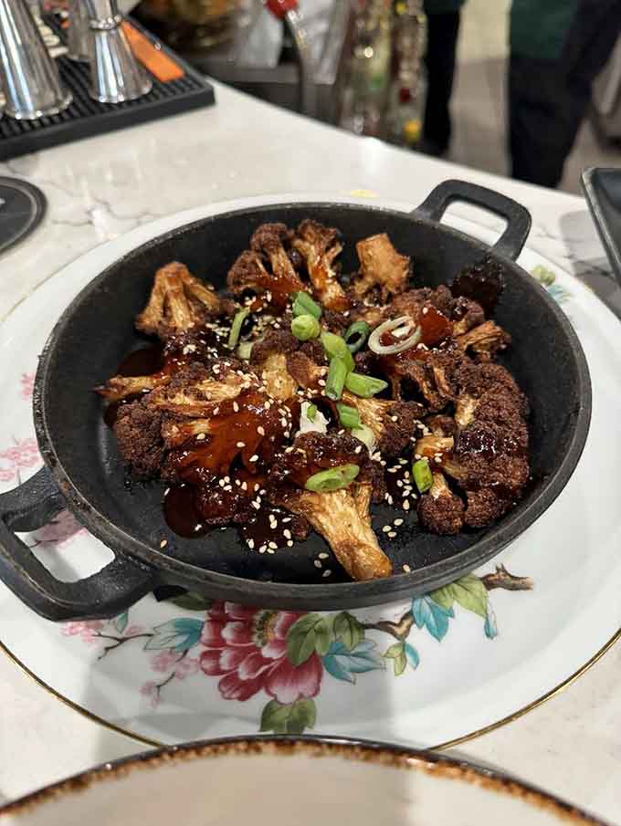 Cauliflower burnt ends in a cast iron skillet prove vegetables can be just as crave-worthy as any meat.