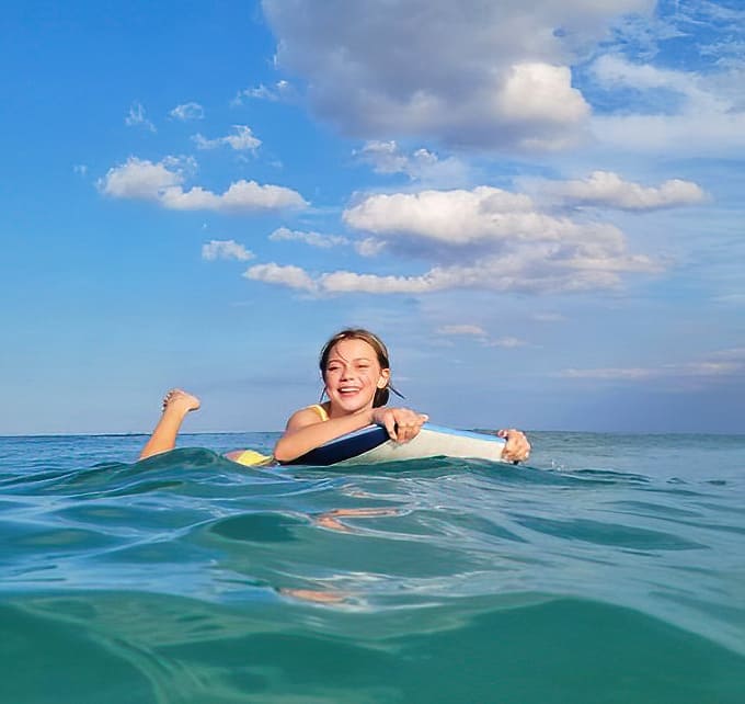 Pure joy captured mid-wave! Nothing says "I'm living my best life" like riding the perfect Lake Worth roller with that crystal-clear water.