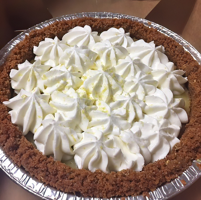 The key lime pie wears its crown of whipped cream rosettes like royalty. One bite and you'll understand why people drive across state lines for this.